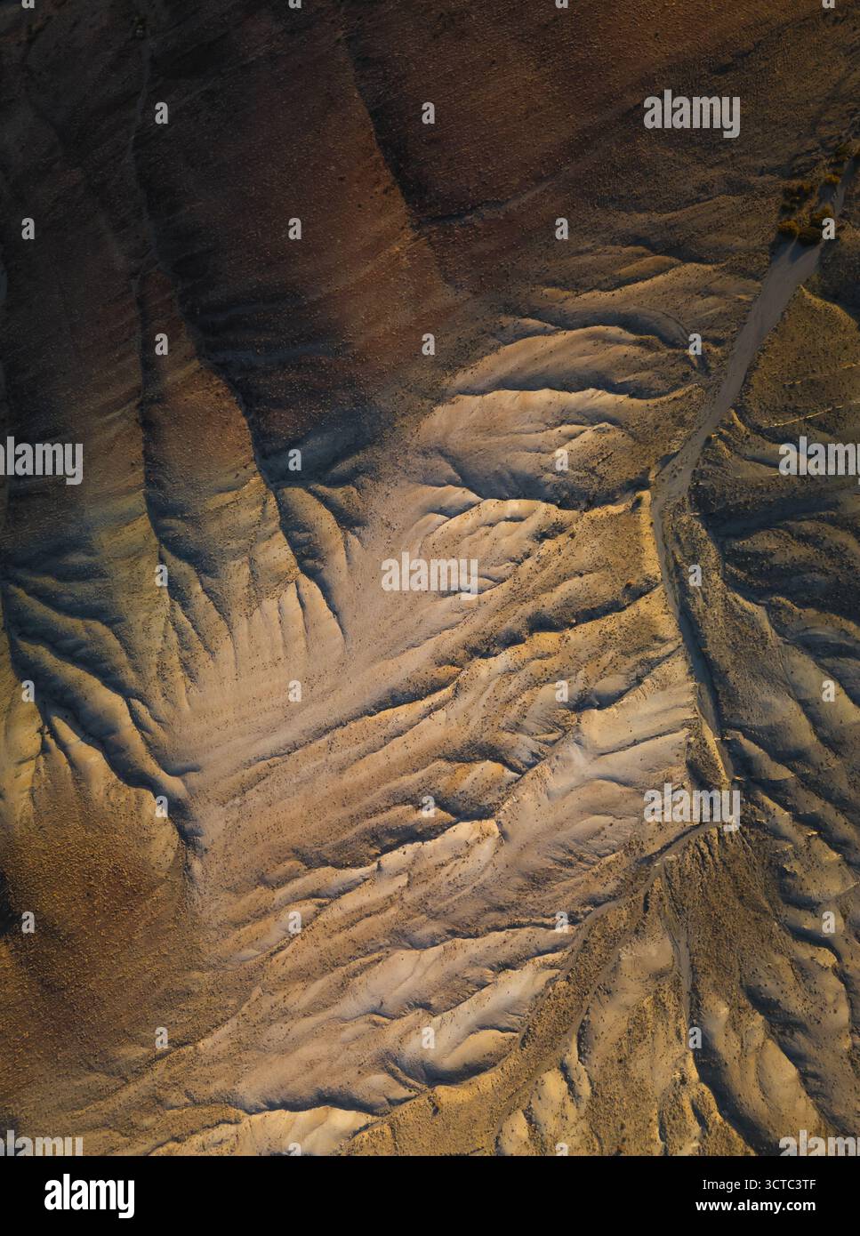 Aerial view of the stark, eroded landscape displaying a network of deep ...