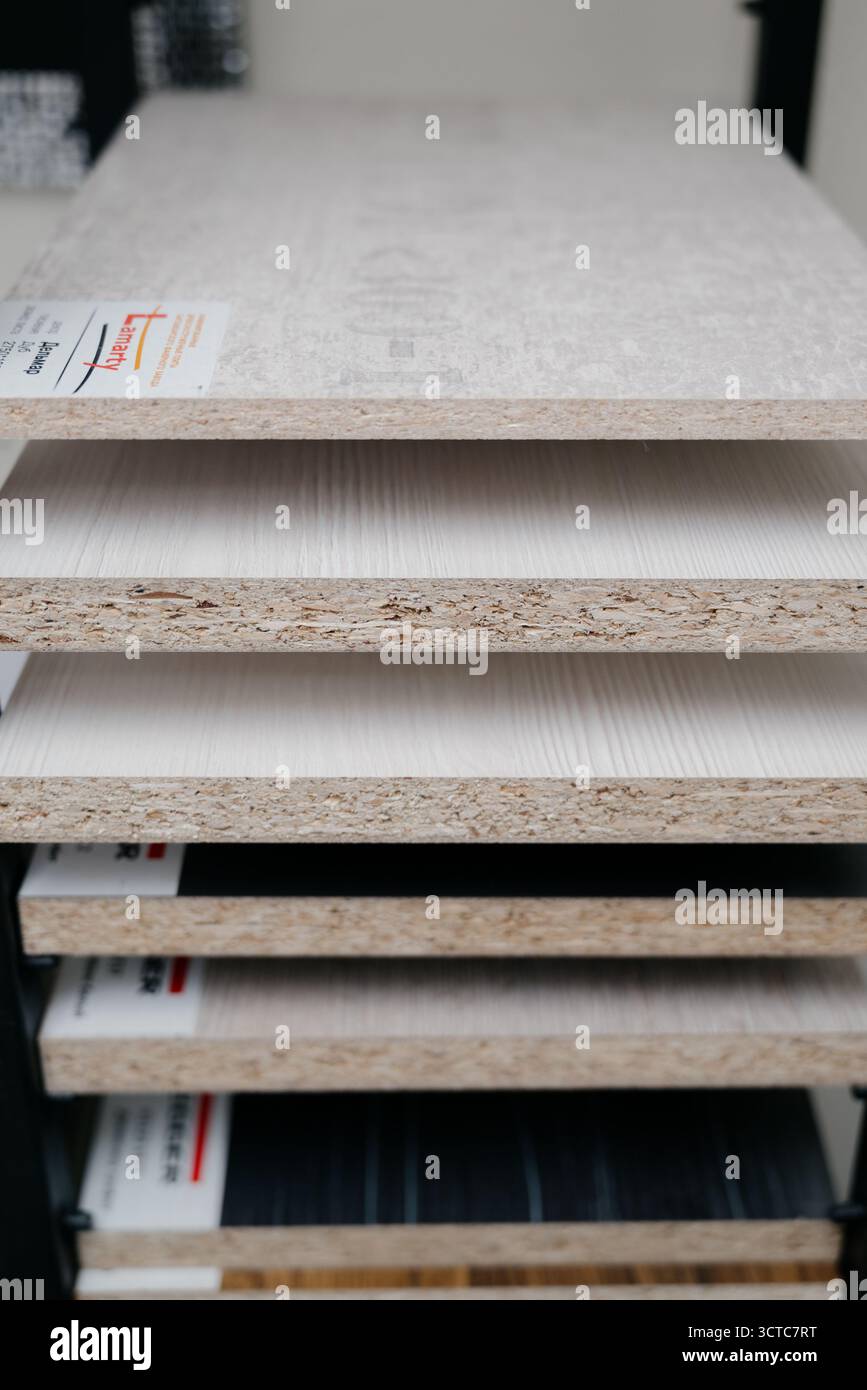 A stack of kitchen cabinet samples of different colors and textures on ...
