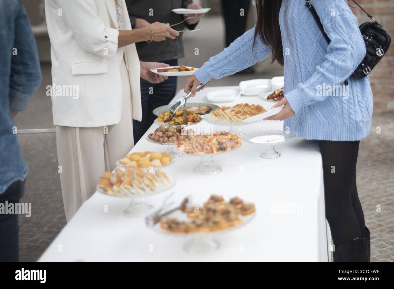 Elegant outdoor reception gathering guests enjoy a variety of delicious ...