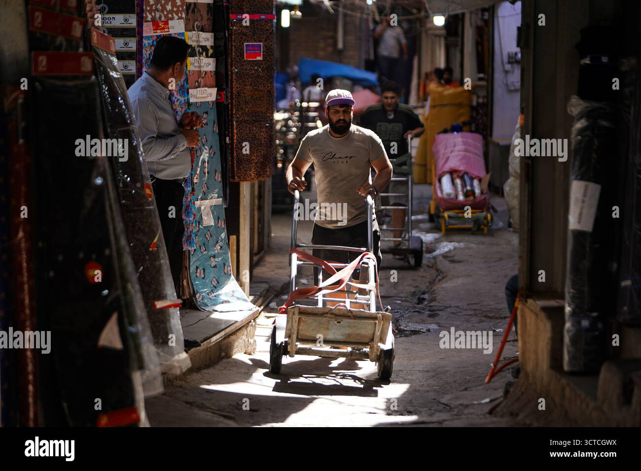 Baghdad, Iraq. 02nd Oct, 2025. An Iraqi porter pushes a cart on Al ...
