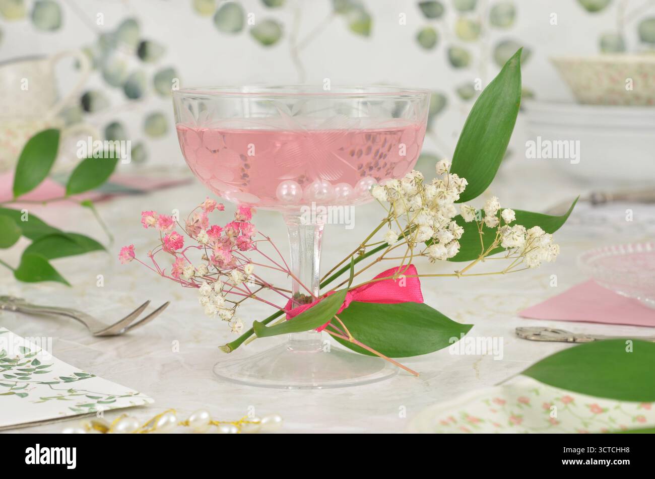 Sakura celebration: pink drink with delicate decorations, white nad ...
