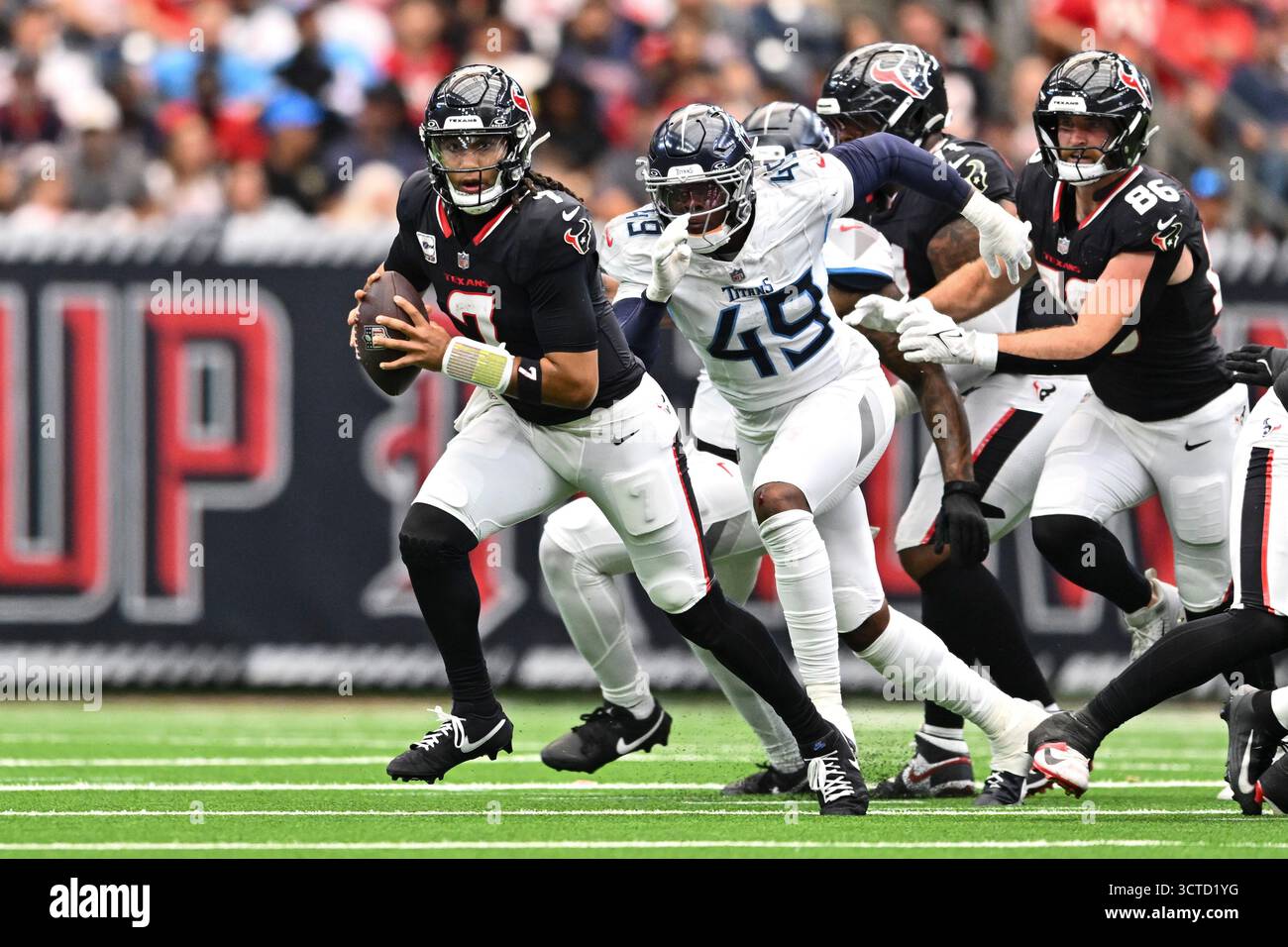 Houston Texans quarterback C.J. Stroud (7) runs the ball under pressure ...