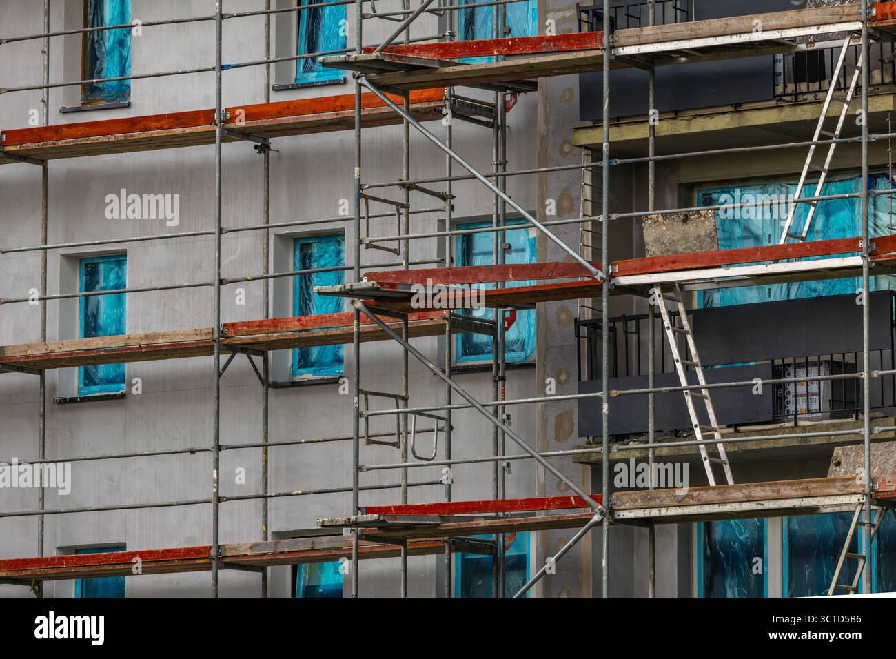 Aluminum scaffolding installed on the facade of a tall building, walls ...
