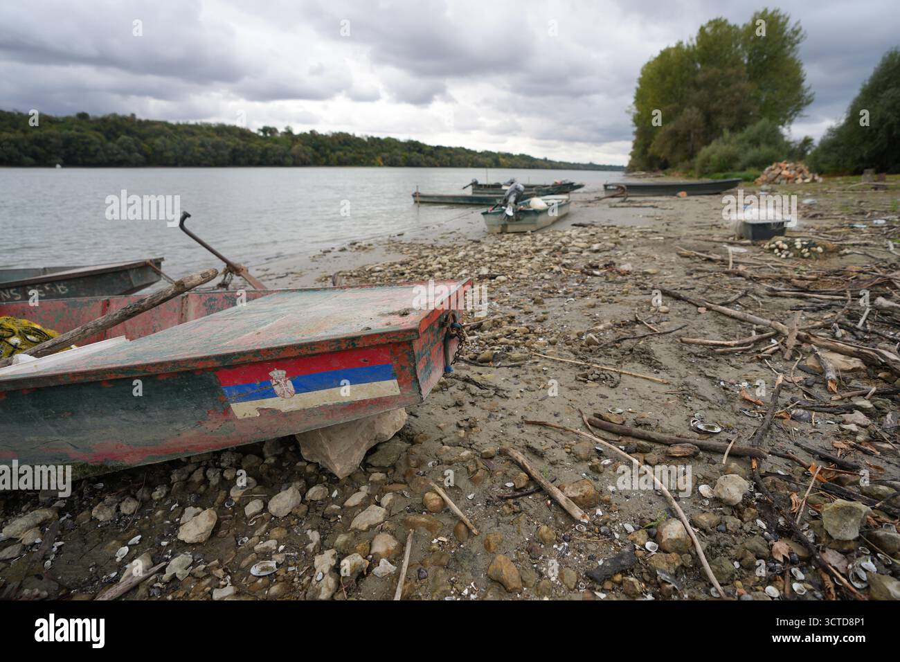 Boats are docked on a bank of the Danube River between Serbia and ...