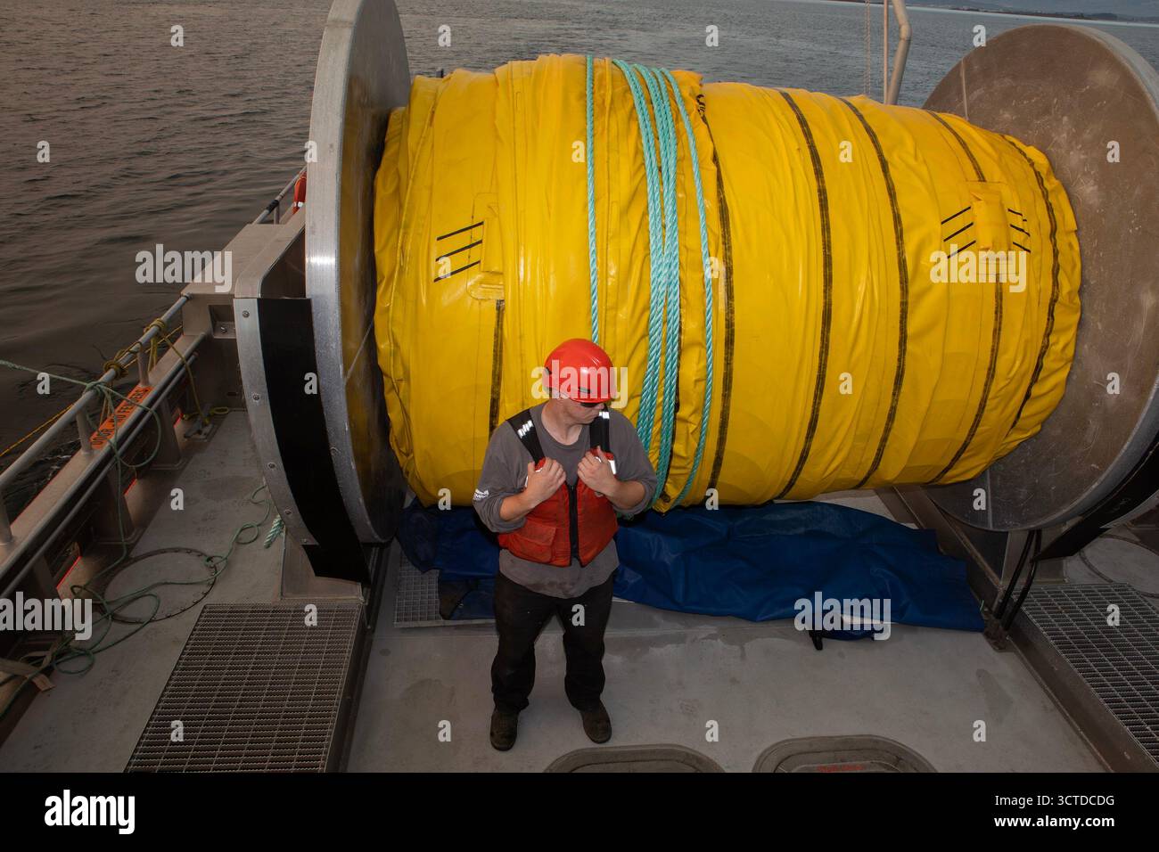 A crew member looks on near an offshore containment boom while aboard ...