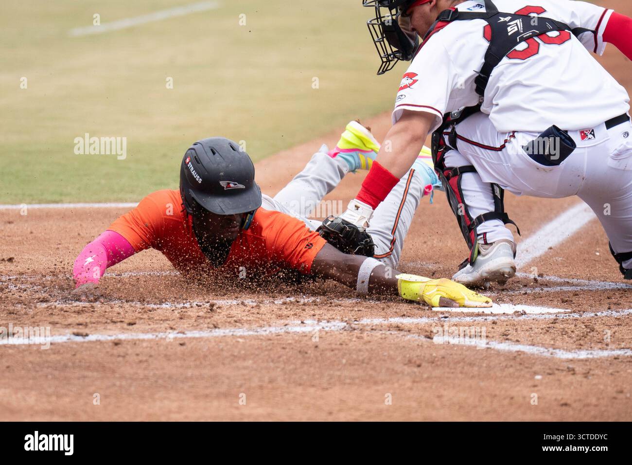 RJ Austin (3) of the Delmarva Shorebirds slides into home during a ...