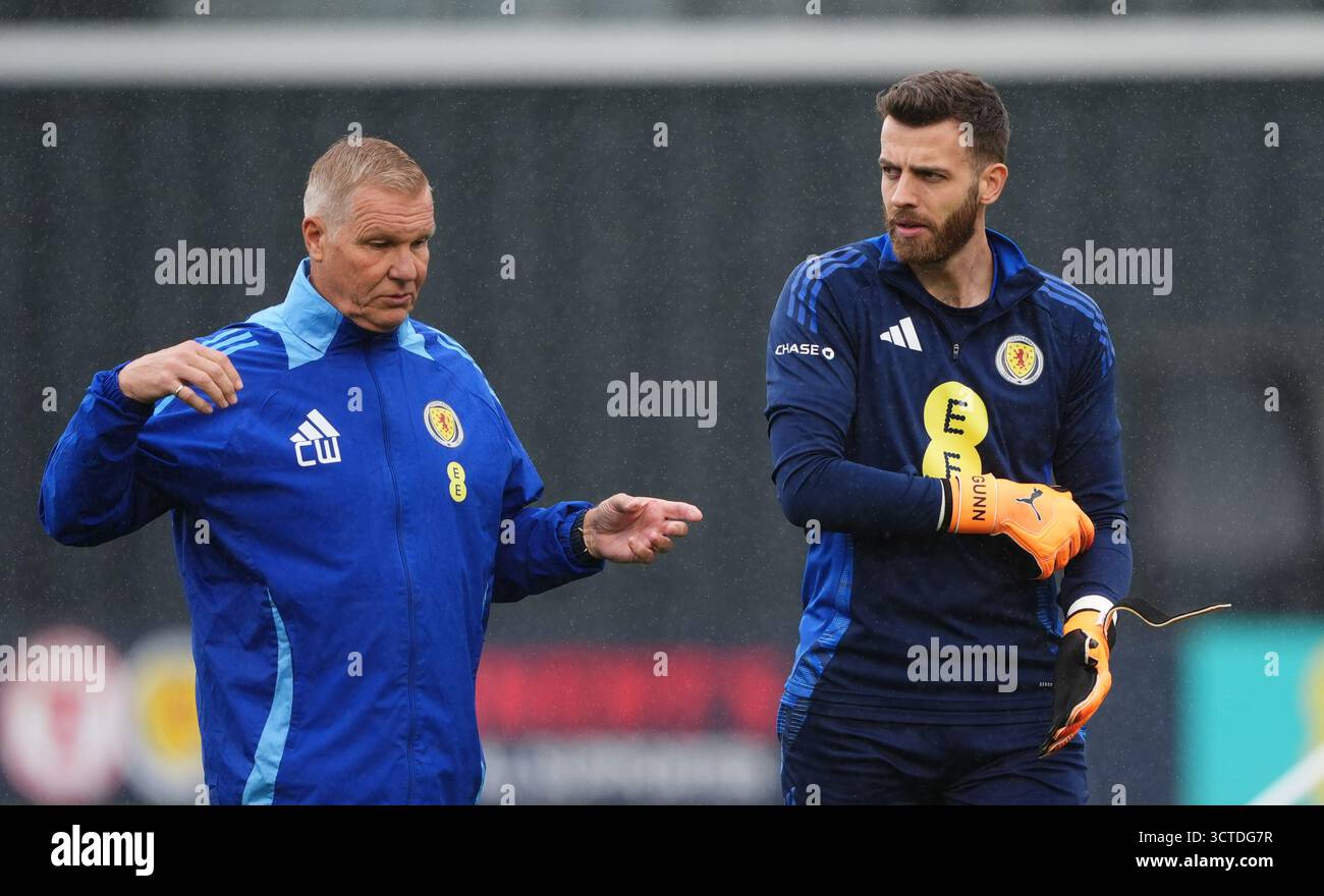 Scotland goalkeeper Angus Gunn (right) speaks with goalkeeping coach ...