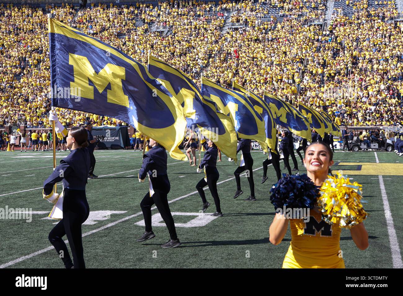 ANN ARBOR, MI - OCTOBER 04: Flag bearers for the Michigan Marching Band ...