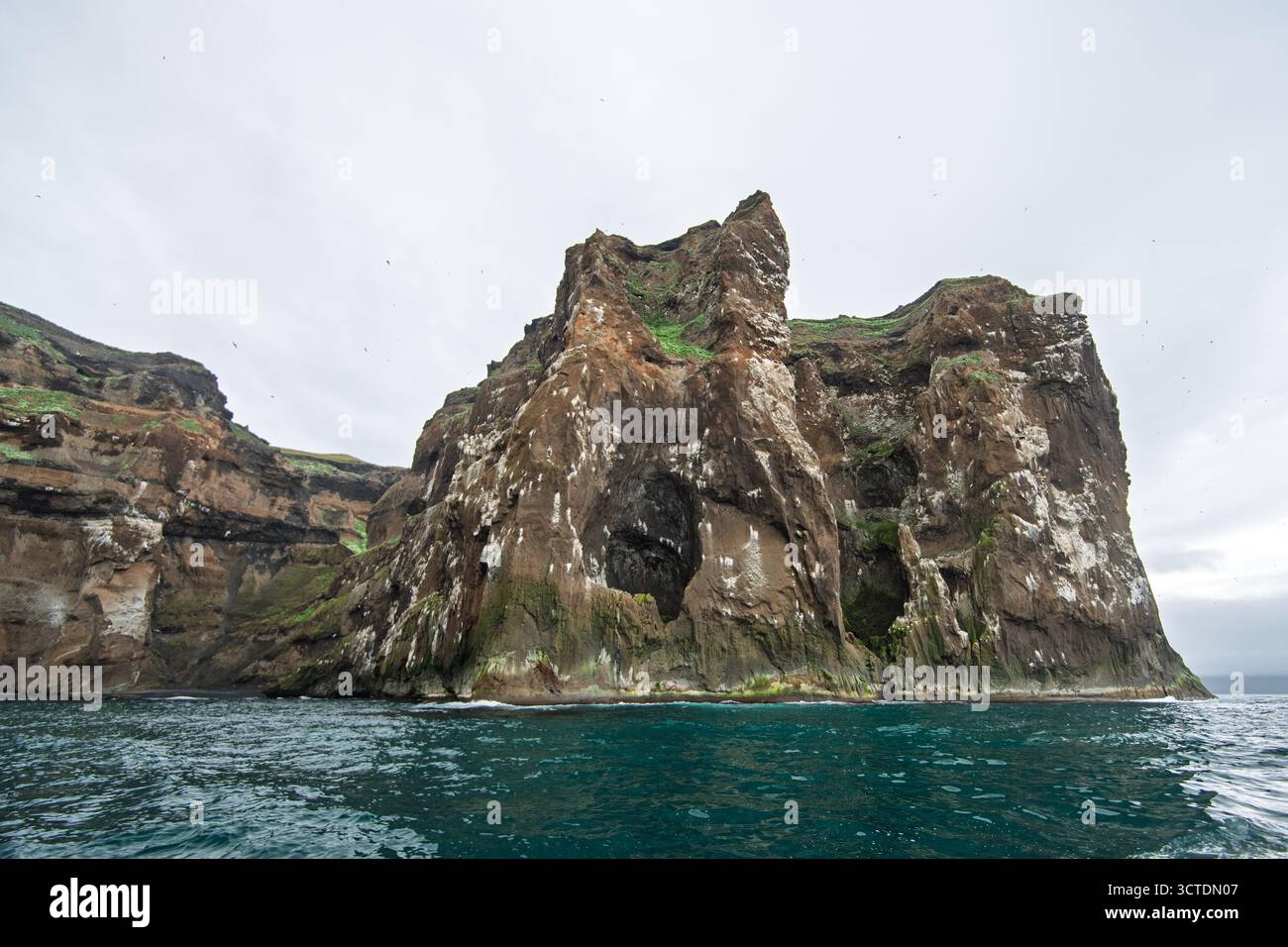 The sheer volcanic cliffs of Drangey island in Skagafjörður, Iceland, a ...