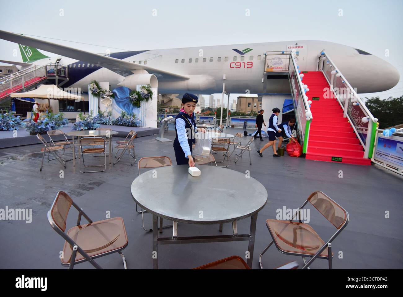 Staff are preparing tables outside the aircraft - themed restaurant ...
