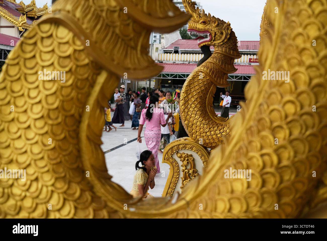 A Buddhist devotee prays Botataung pagoda during the full moon day of ...