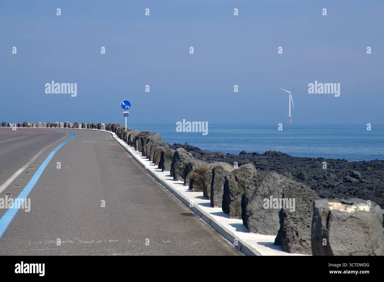 A line of basalt bollards borders the Haengwon coastal road as it ...
