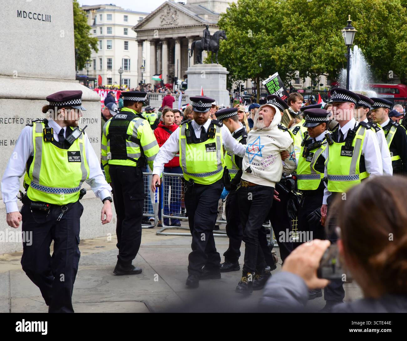 A pro Palestine demonstrator wearing the symbols of the Star of David ...