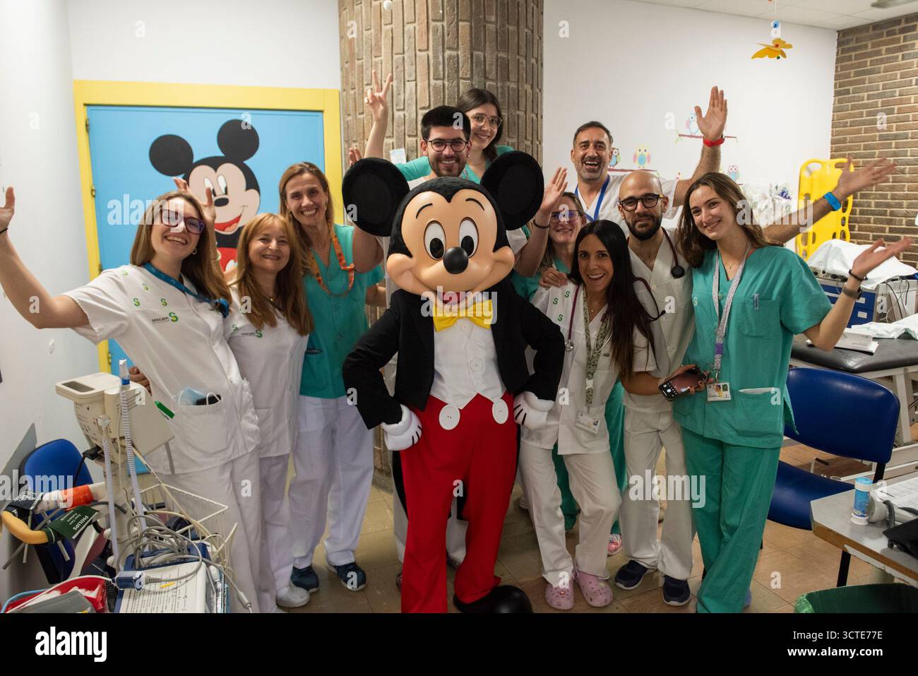 Mickey Mouse poses with the doctors in the pediatric area of the ...