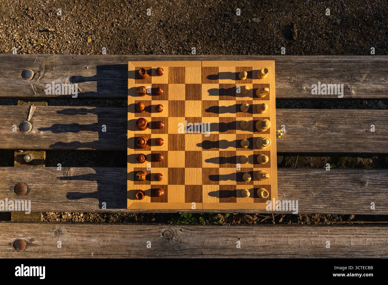 Top down view of chessboard with arranged chess pieces placed on wooden ...
