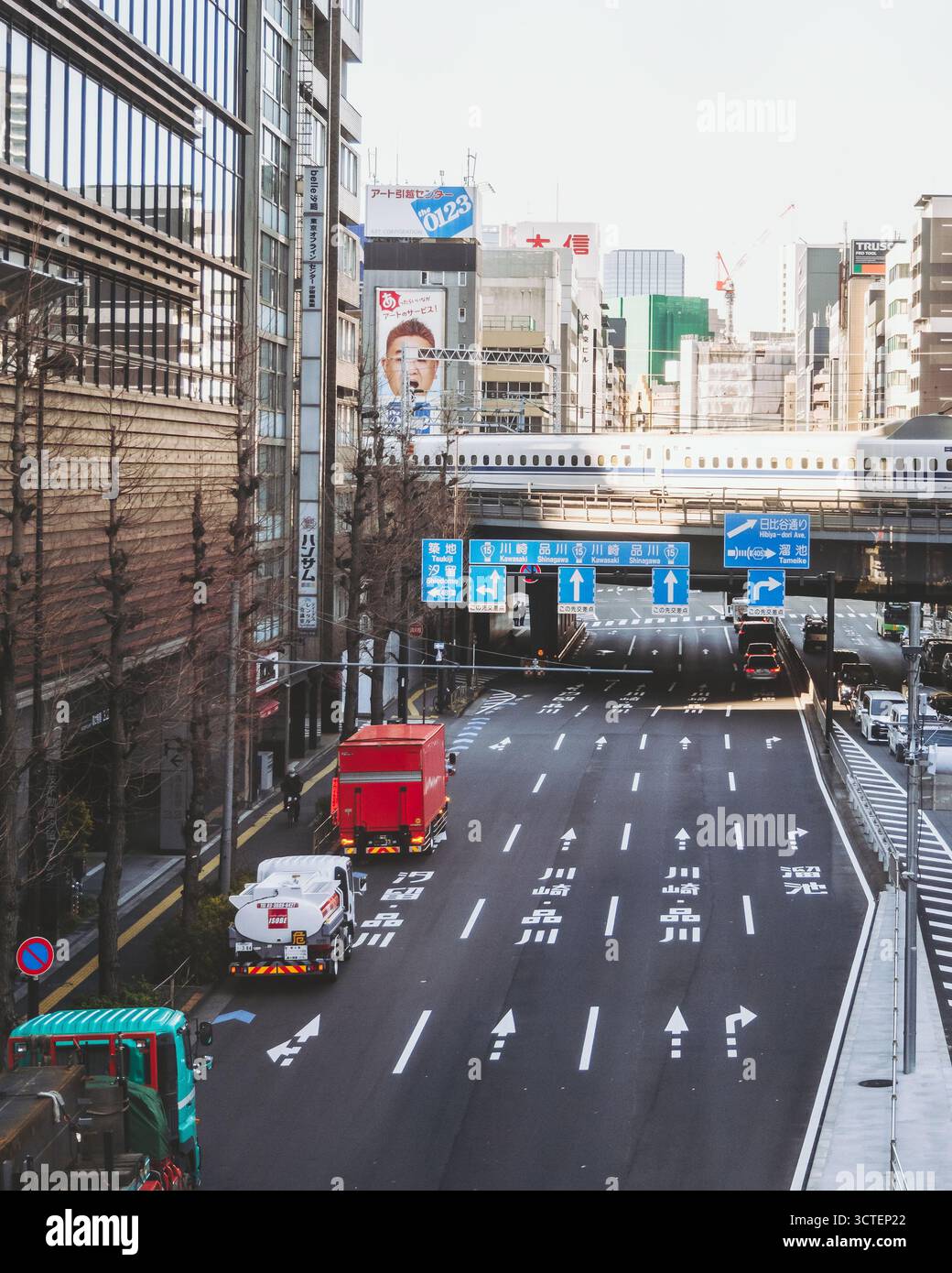 Shimbashi, Japan - 10 March 2025: View of the bustling city street where vehicles navigate under ...