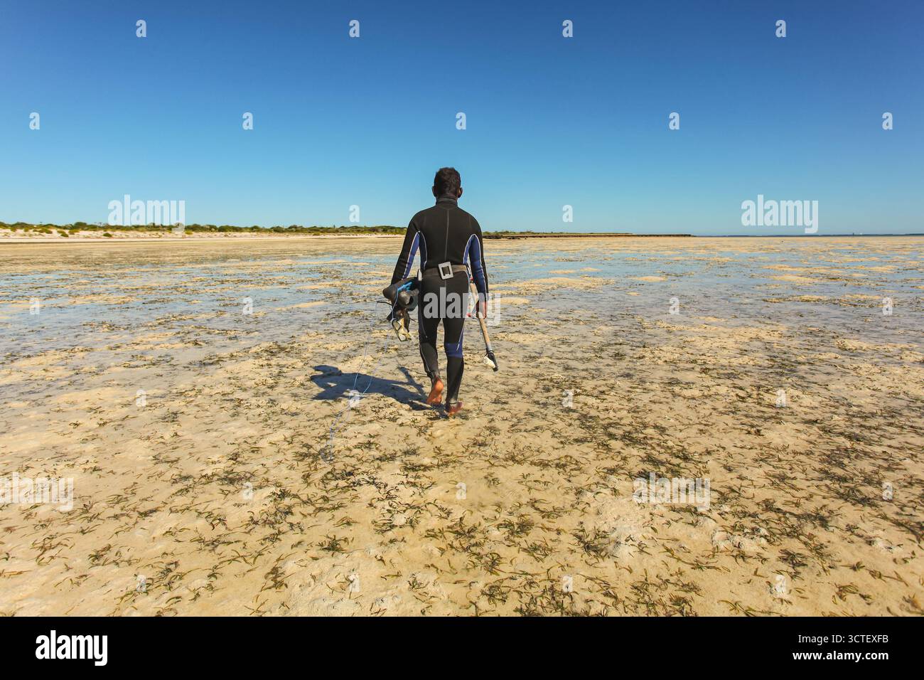 Local Malagasy fisherman in neoprene wetsuit, with snorkel and simple ...