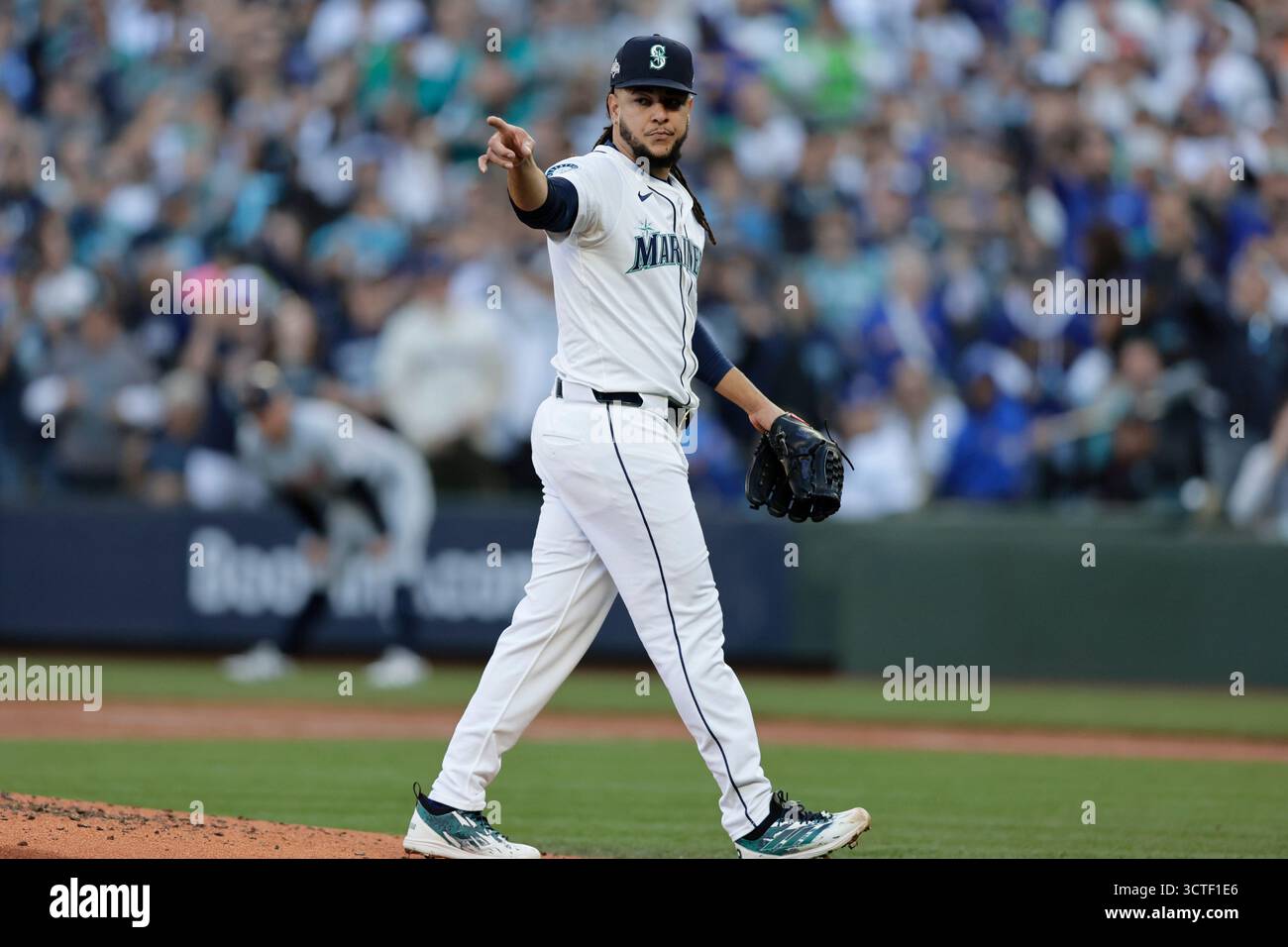 Seattle Mariners starting pitcher Luis Castillo points to the third ...