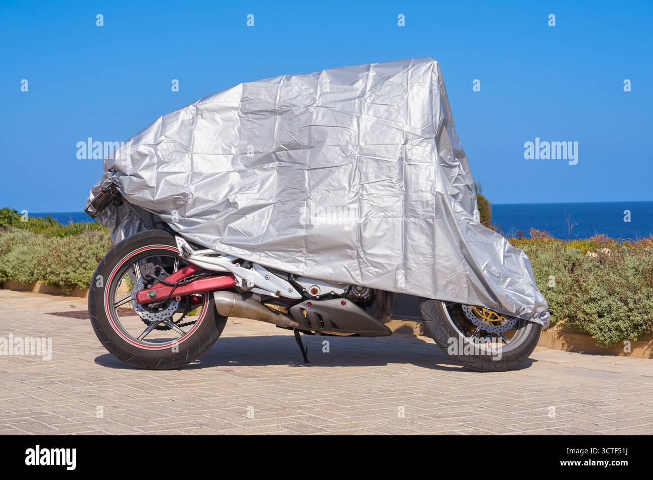 Motorcycle under silver cover hi-res stock photography and images - Alamy