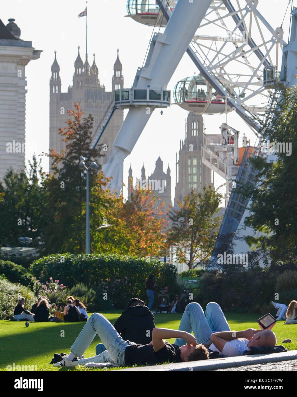 People sunbathe in Jubilee Gardens, Monday, Oct. 6, 2025, in London ...
