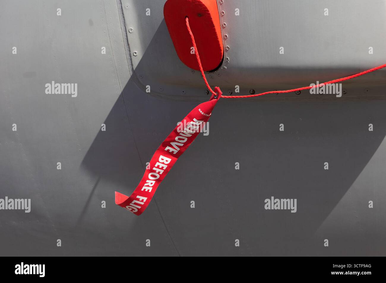 Remove before flight - safety warnign red ribbon and tag. Detail of ...