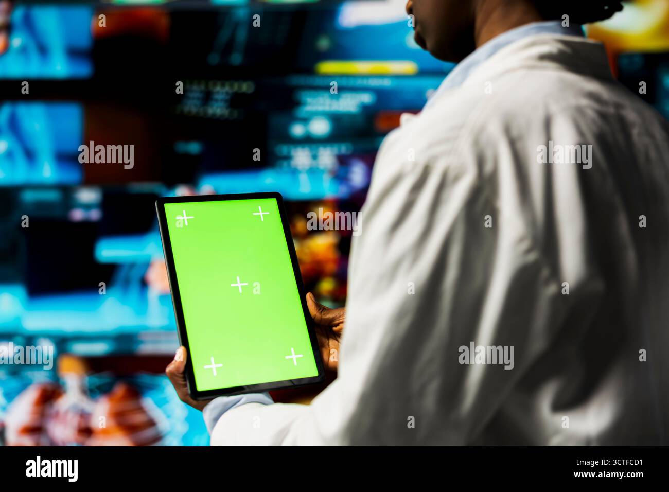 Doctor monitoring medical research data and 3D anatomy models ...