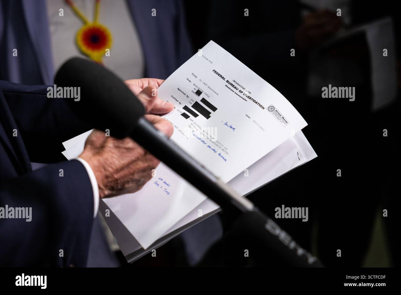 Sen. Ron Johnson (R-Wis.) holds documents as he speaks with reporters ...