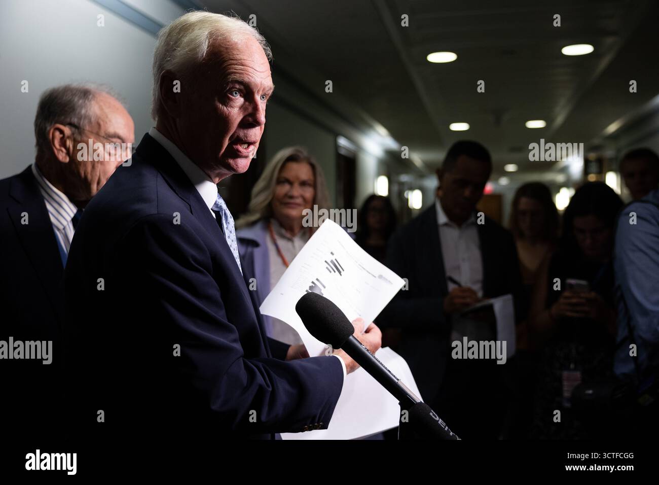 Sen. Ron Johnson (R-Wis.) displays documents as he speaks with ...