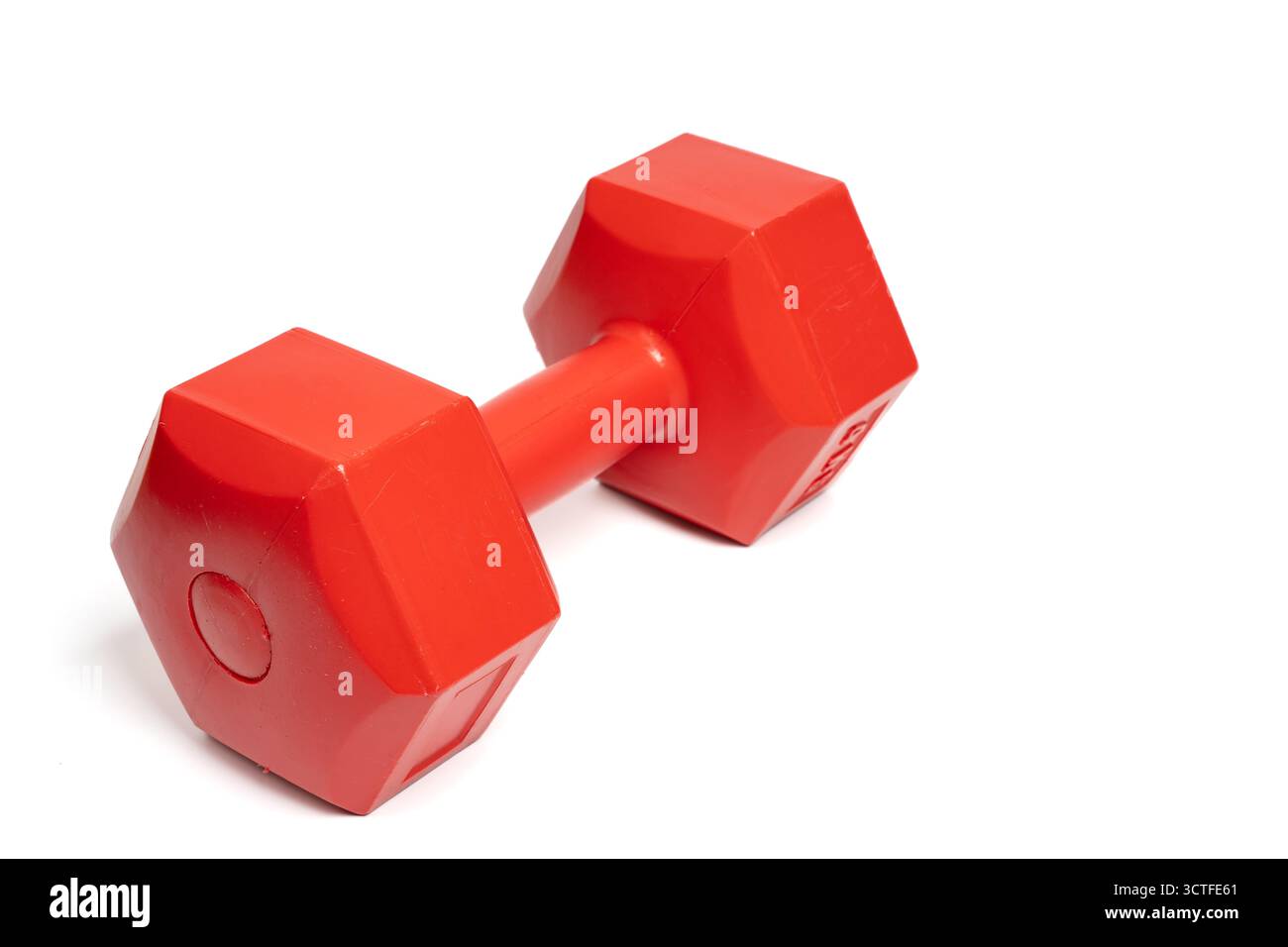 Red hexagonal dumbbell on isolated white background, fitness equipment ...