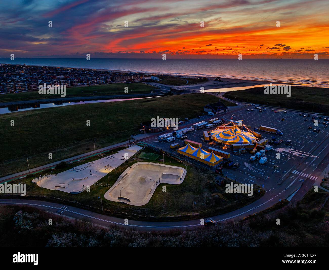Aerial view of coastal sunset with vibrant sky over ocean skatepark ...