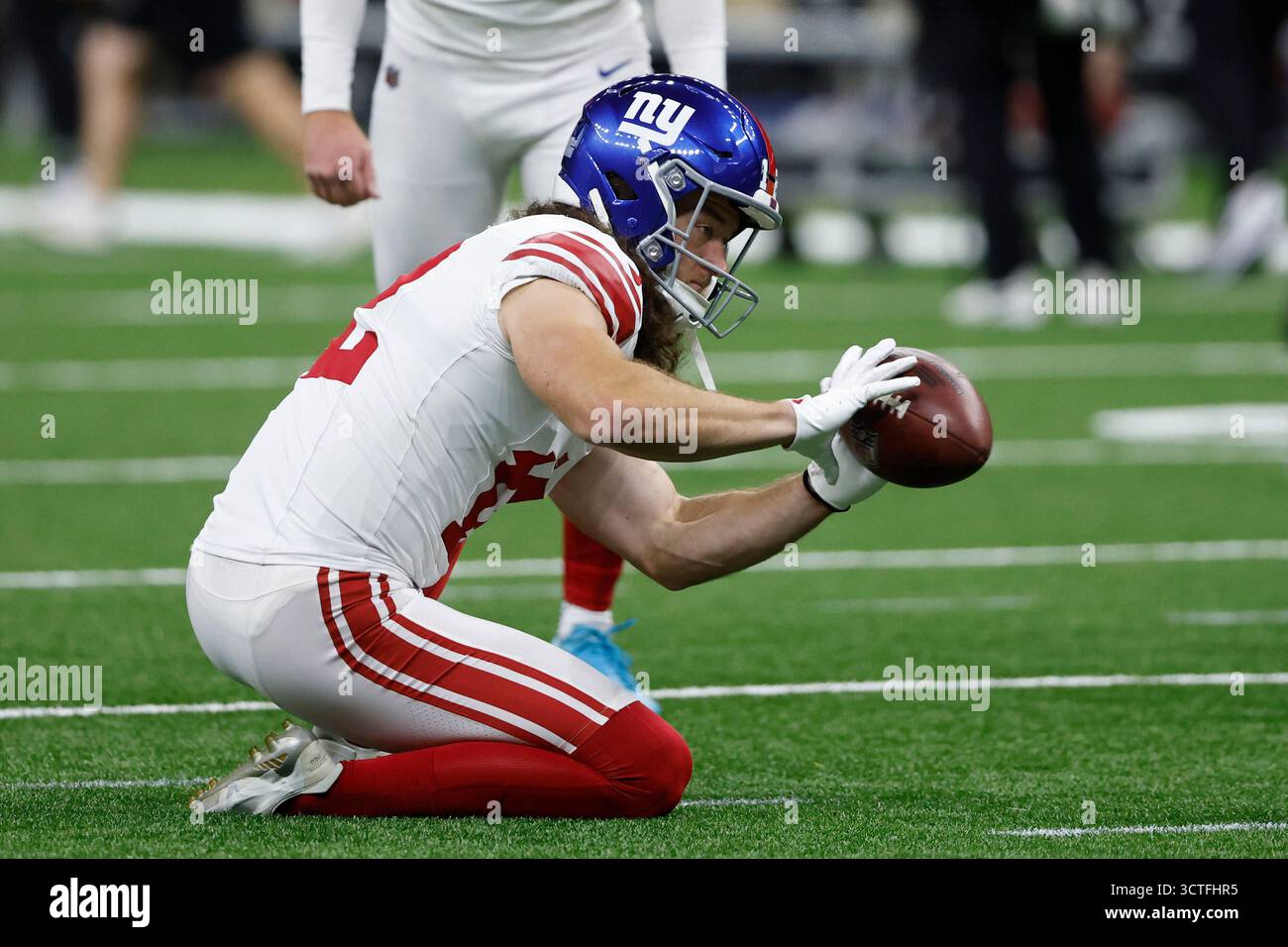New York Giants punter Jamie Gillan (12) takes the snap in warm ups ...