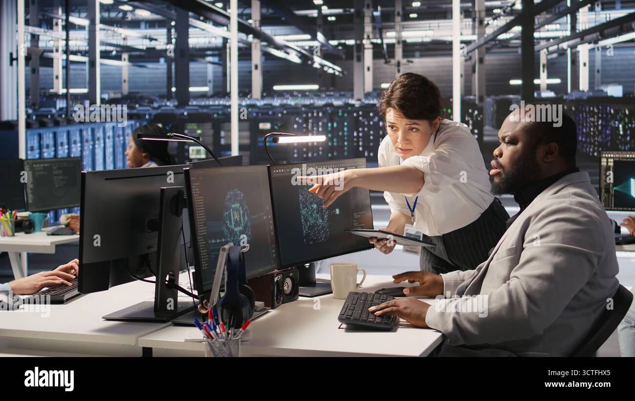 Server room manager supervise technician examining deep learning algorithms. Data center team ...