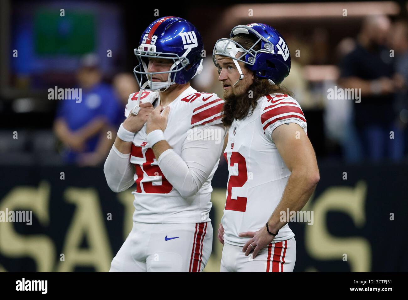 New York Giants long snapper Casey Kreiter (59) talks with punter Jamie ...