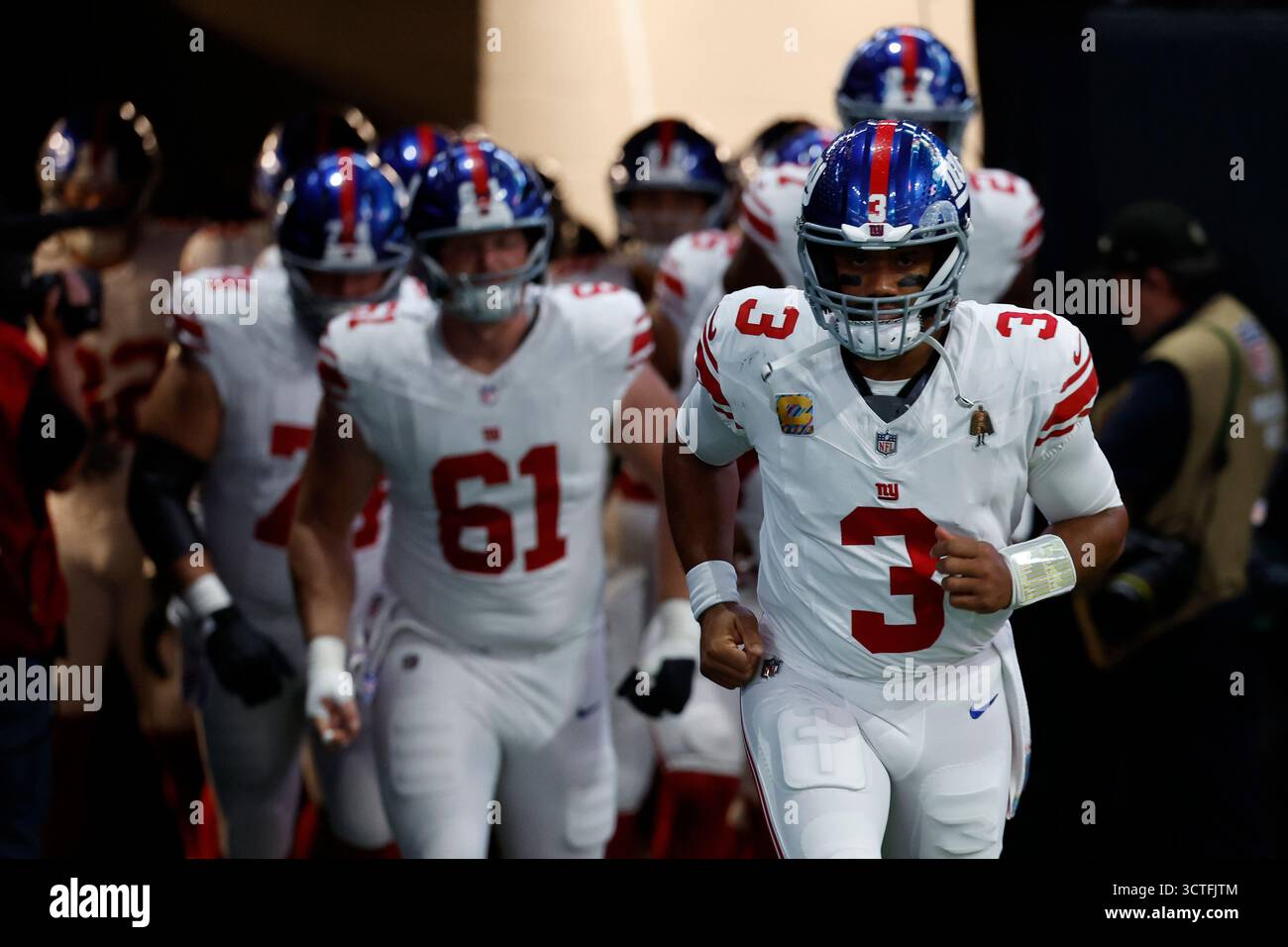 New York Giants quarterback Russell Wilson (3) leads the team onto the ...