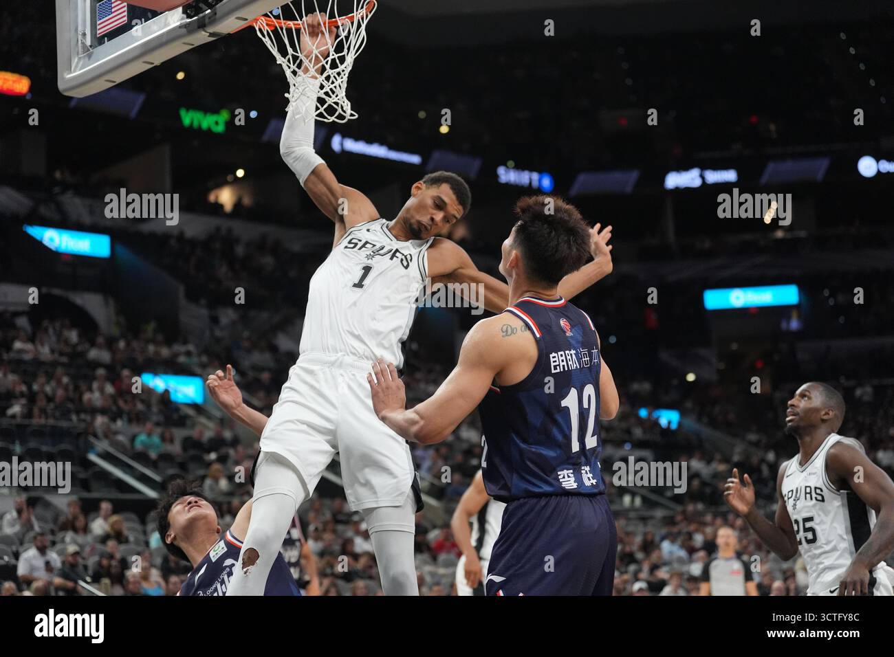 San Antonio Spurs forward/center Victor Wembanyama (1) hangs on the rim ...