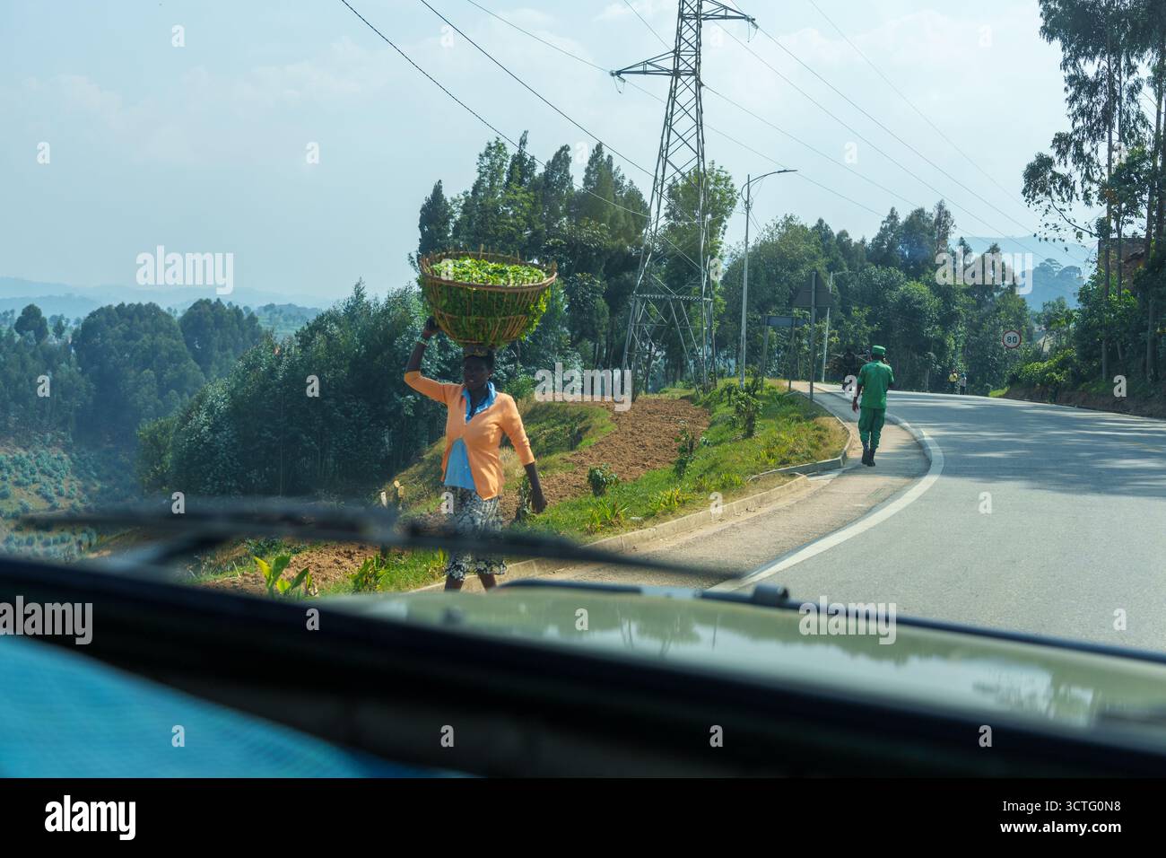 Nyungwe Rwanda September 5 2025; Through car window woman along highway ...