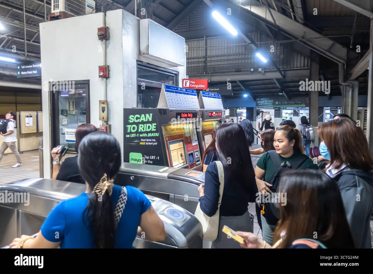 crowd of people at metro station, with a ticket vending machine and ...