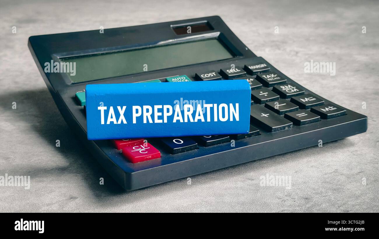 Tax Preparation Text on Blue Block Resting on Professional Calculator ...