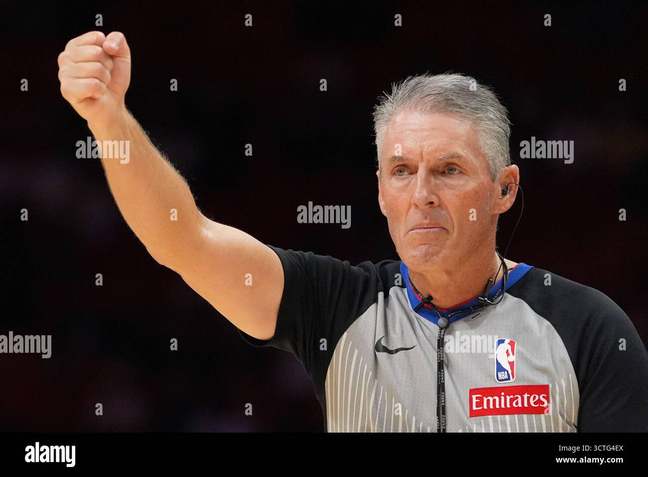 Referee Scott Foster, wearing an earpiece, signals a call during the ...