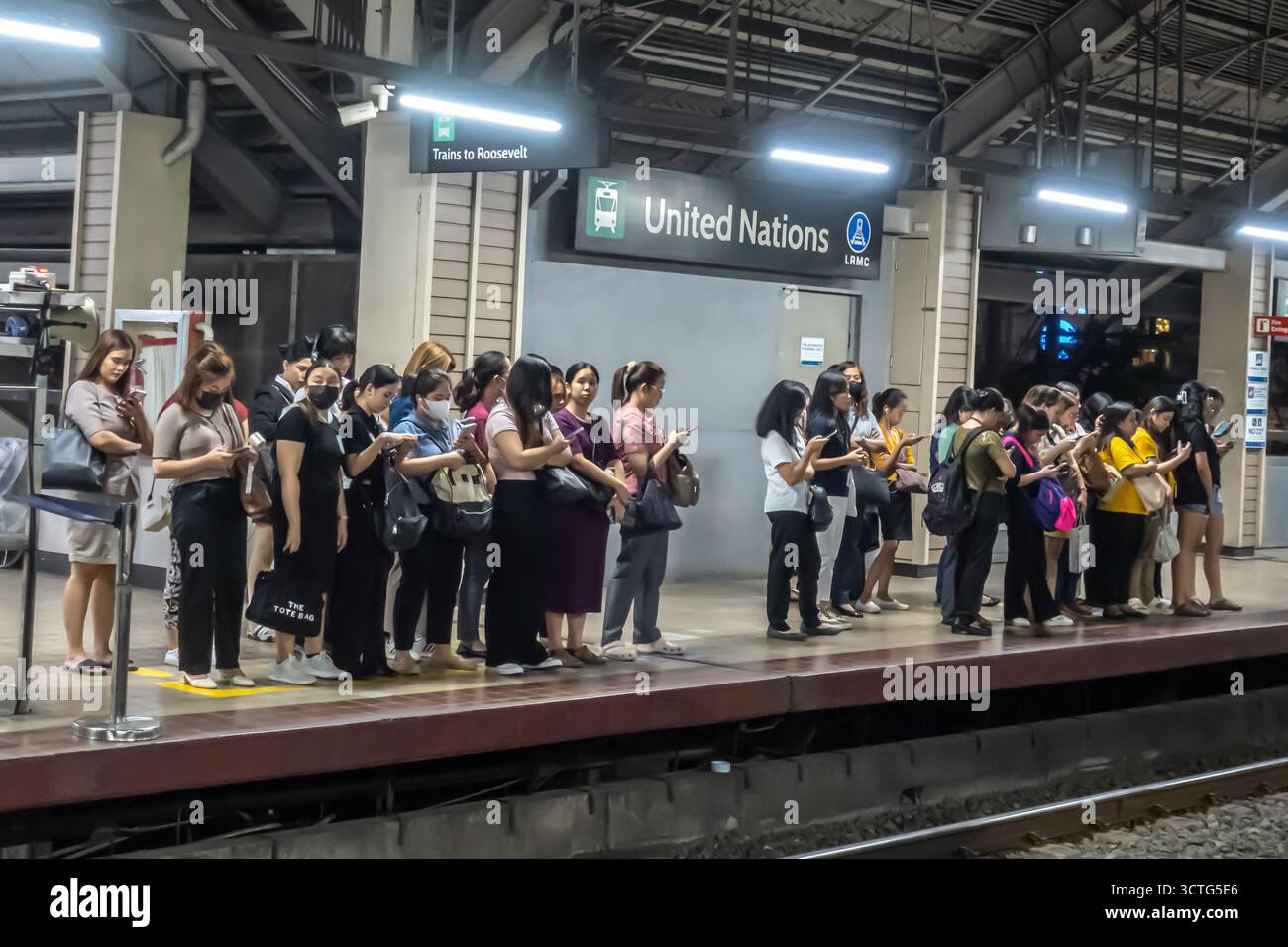 Commuters wait for a train at United Nations an elevated Light Rail ...