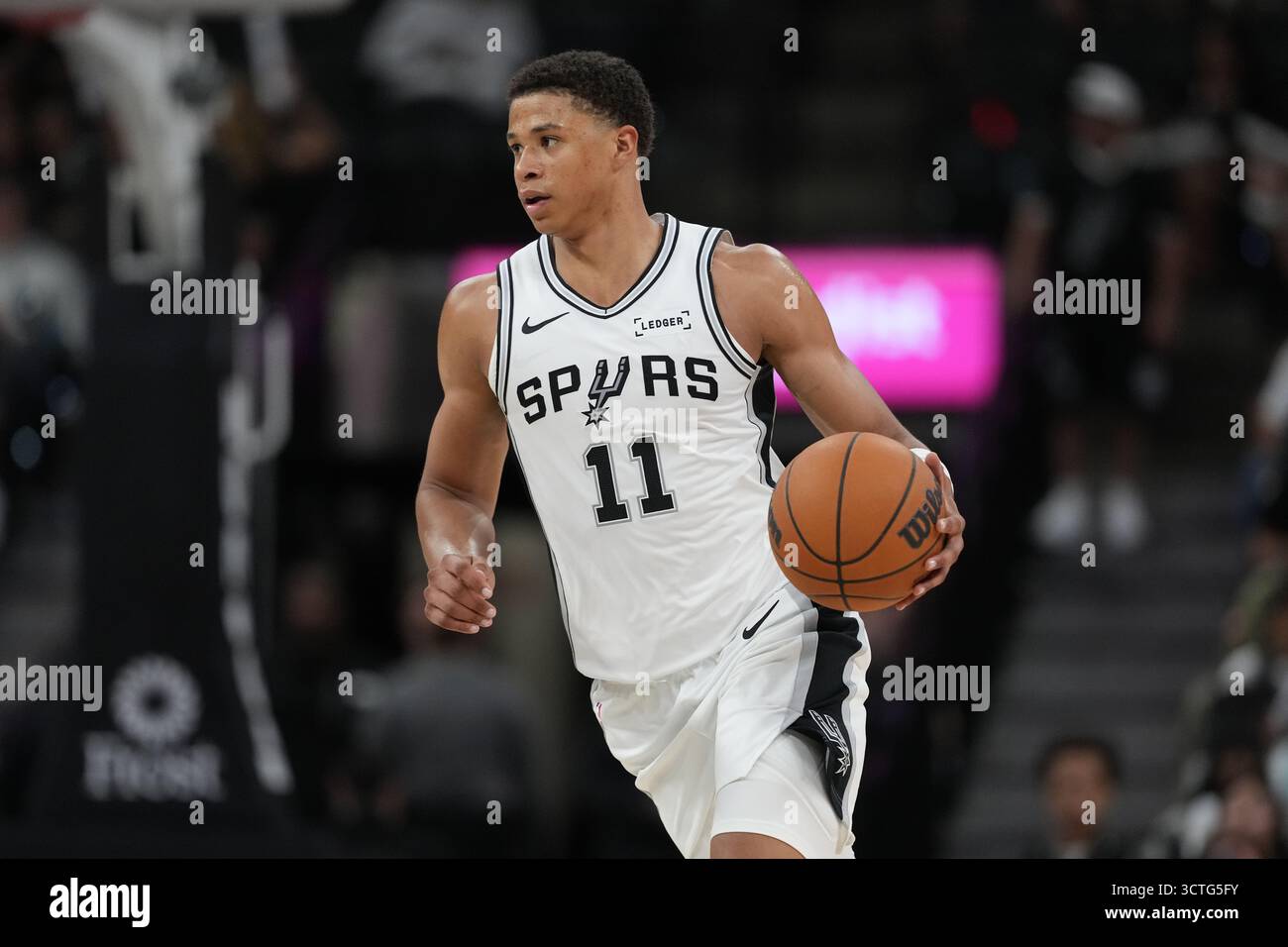 San Antonio Spurs forward Carter Bryant (11) takes the ball up court ...