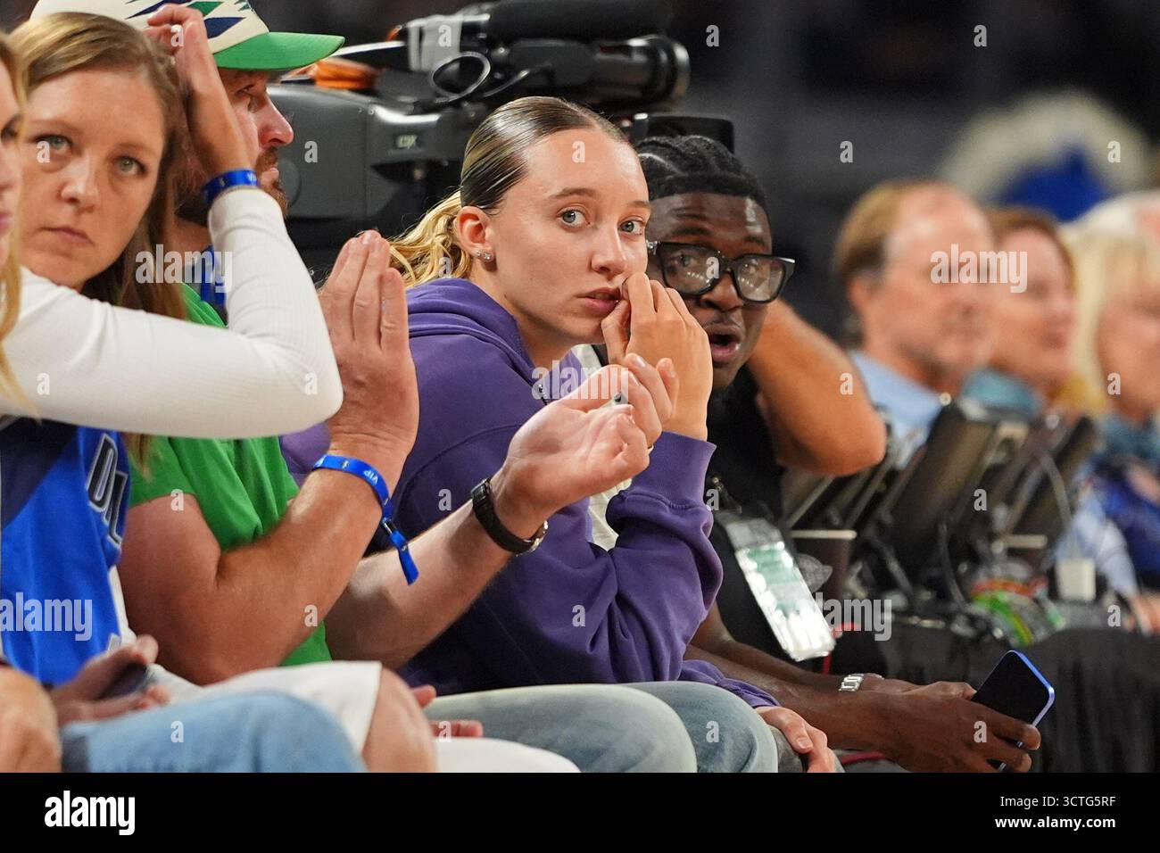 Dallas Wings Paige Bueckers watches a preseason NBA basketball game ...