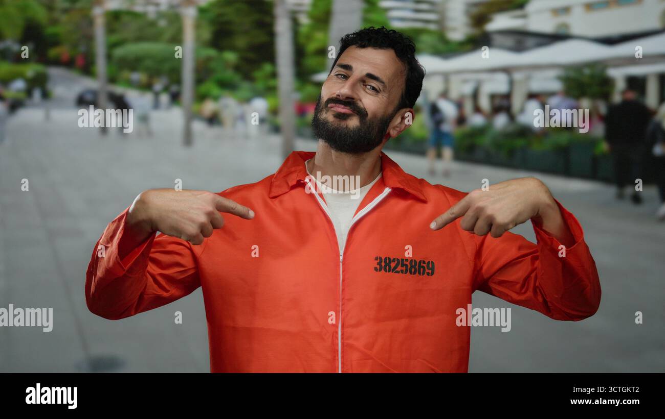 Hispanic man with beard wearing prison jumpsuit stands confidently on a ...