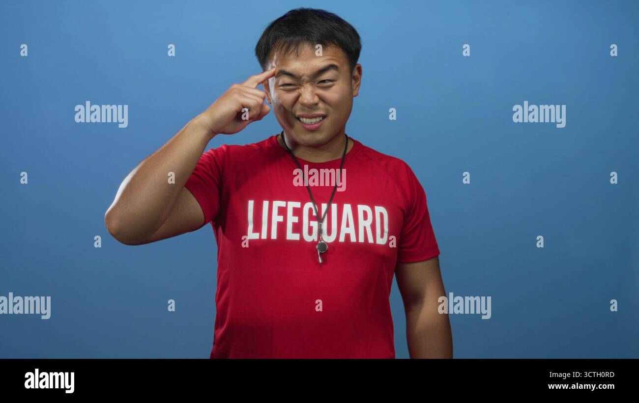 Chinese man wearing red lifeguard shirt pointing finger to head in a ...