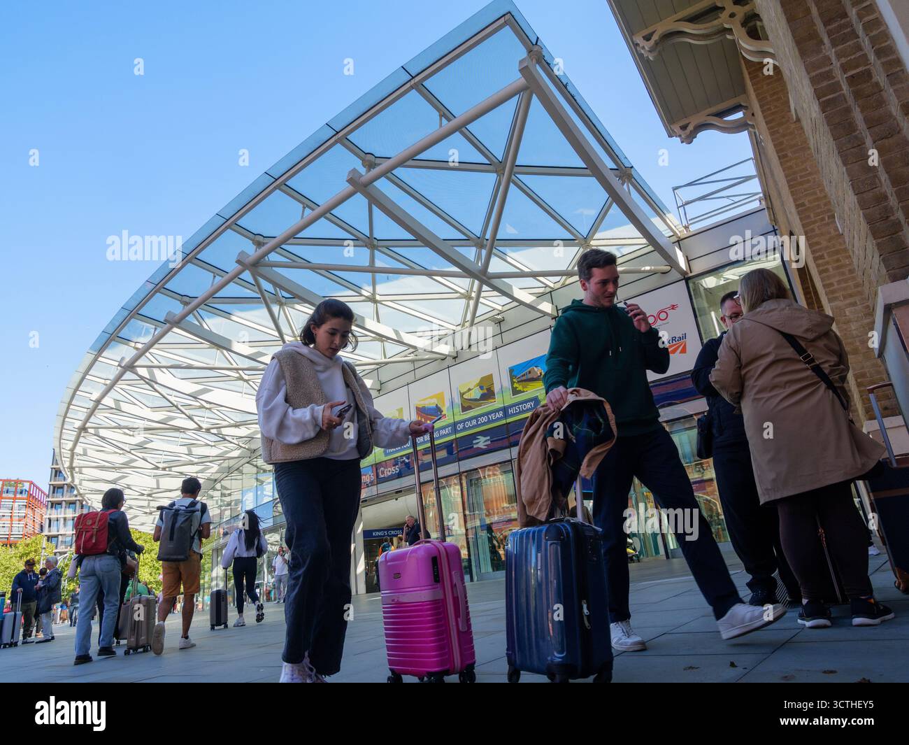 Commuters walk past the modern structure of the entrance to King's ...