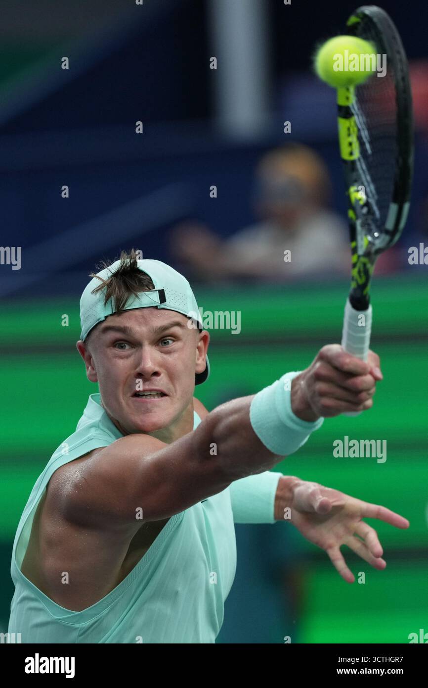 Holger Rune, of Denmark returns a backhand shot from Giovanni Mpetshi Perricard, of France ...