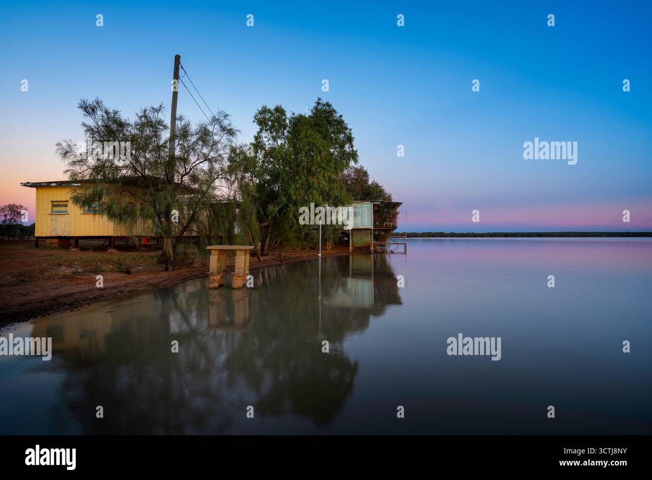 Holiday shacks on shore of Lake Dunn at dawn, Queensland, Australia ...