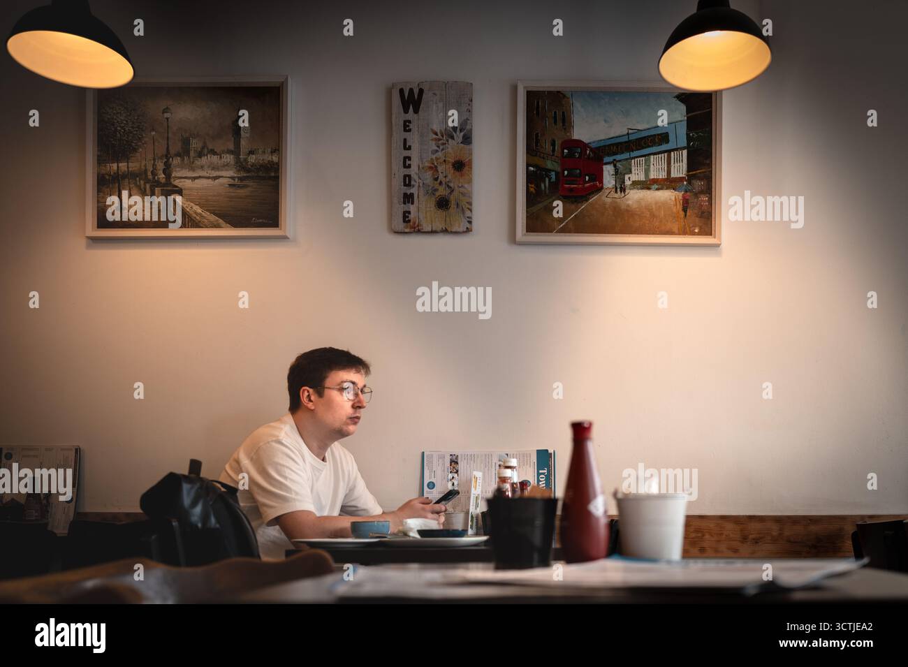 Eating while using phone hi-res stock photography and images - Alamy