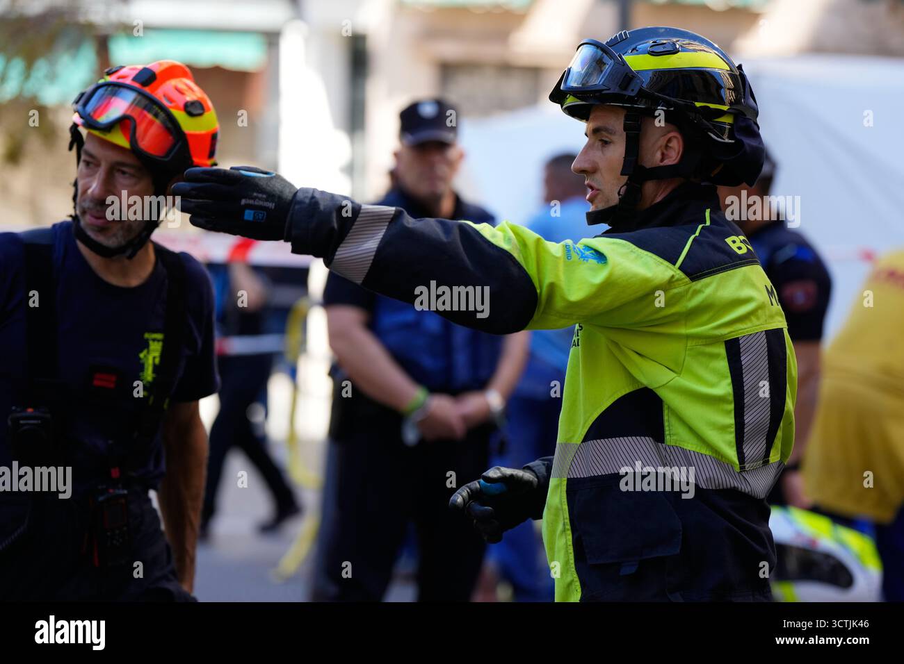 Emergency personnel respond to the scene of a building collapse in ...