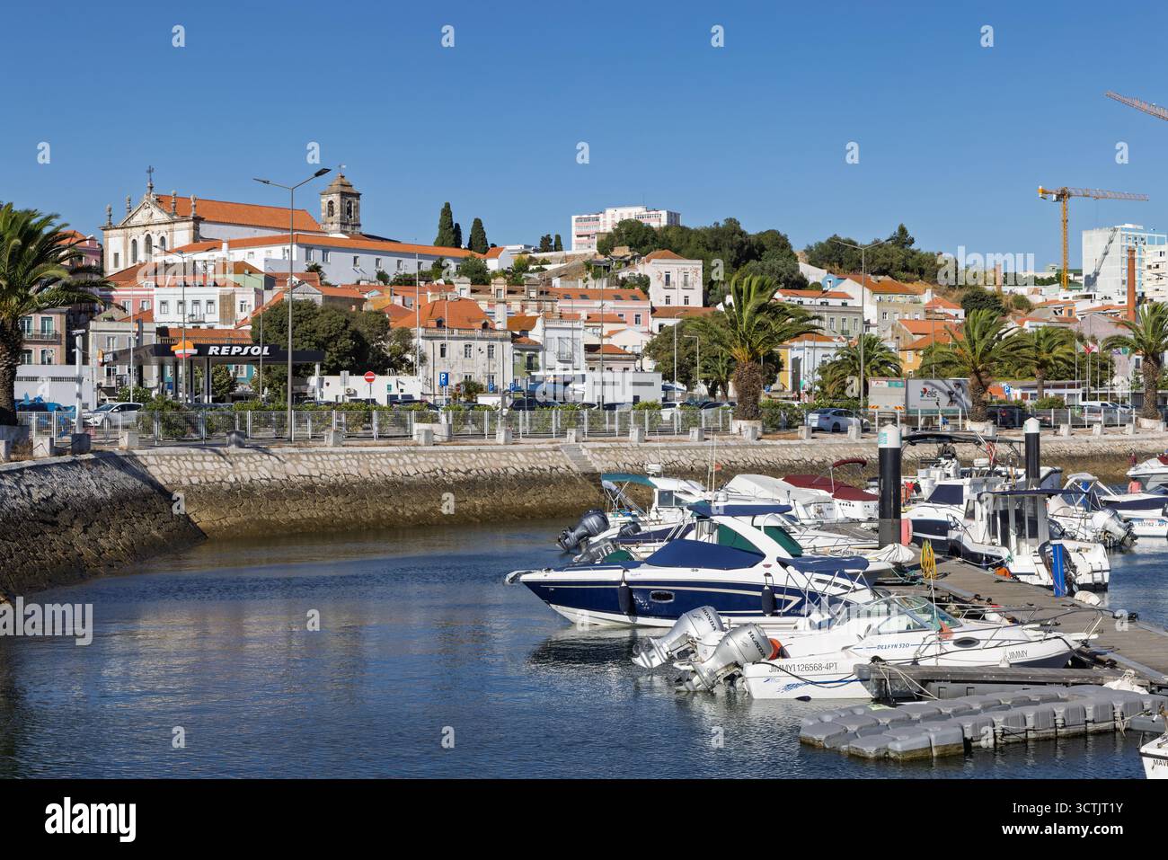 Setúbal's marina with small boats and historic buildings with terra ...